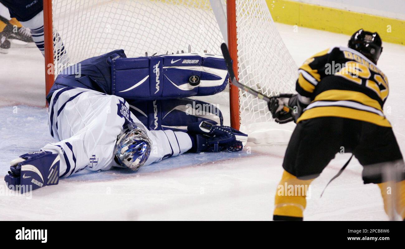 Toronto Maple Leafs goalie Jean-Sebastien Aubin, left, lies on his side ...