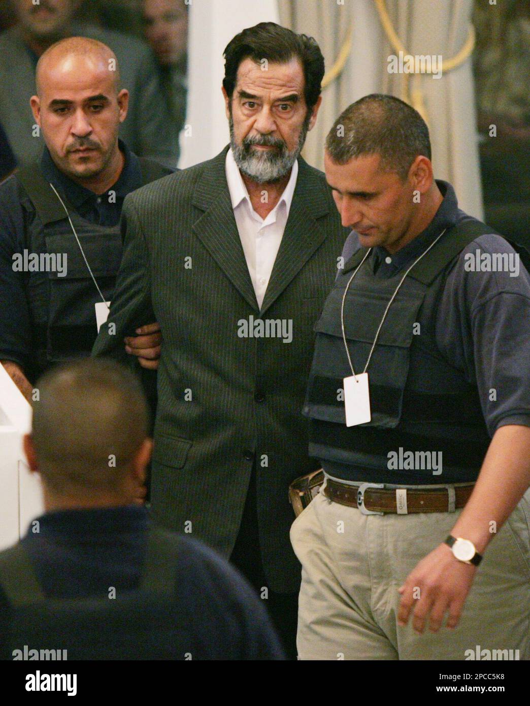 ** FILE ** Saddam Hussein is led into court in Baghdad's heavily ...