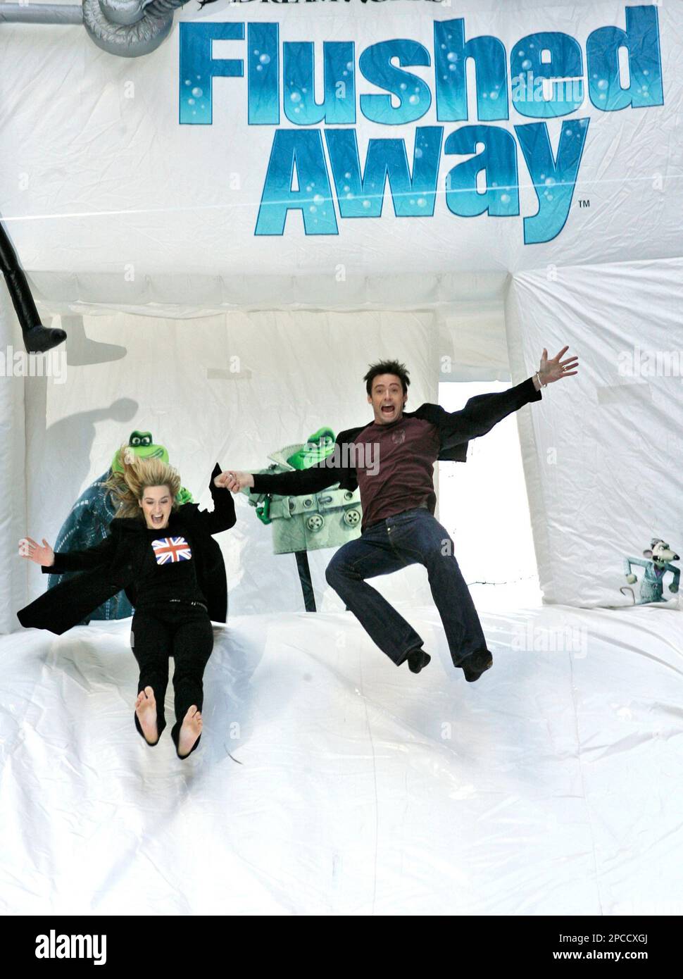 Actors Kate Winslet, left, and Hugh Jackman slide down a 30-foot ...