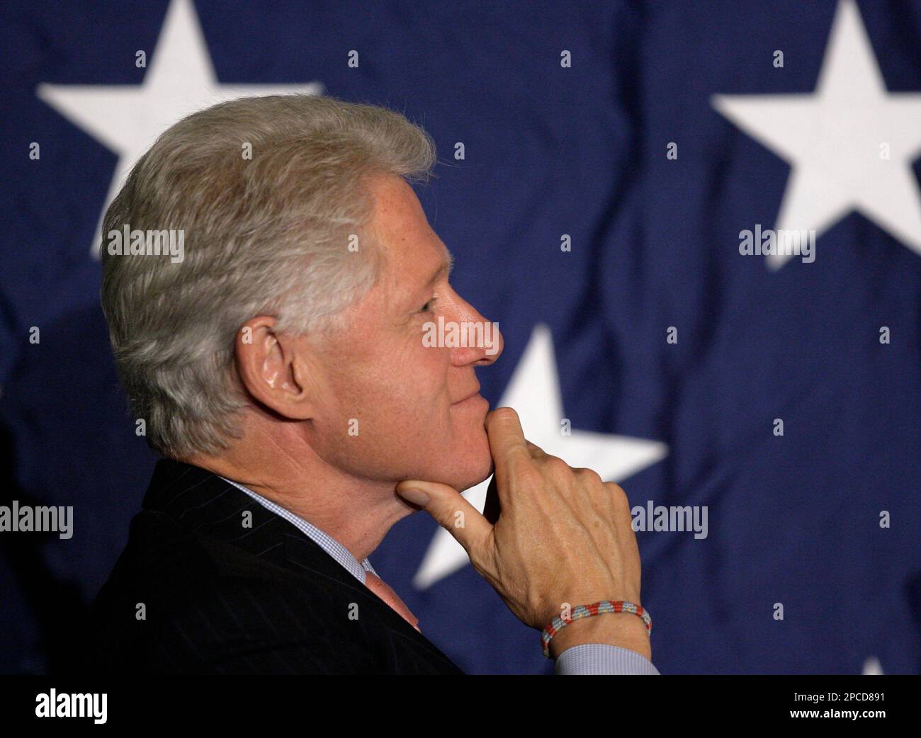 Former President Bill Clinton smiles as he listes to his wife Sen ...
