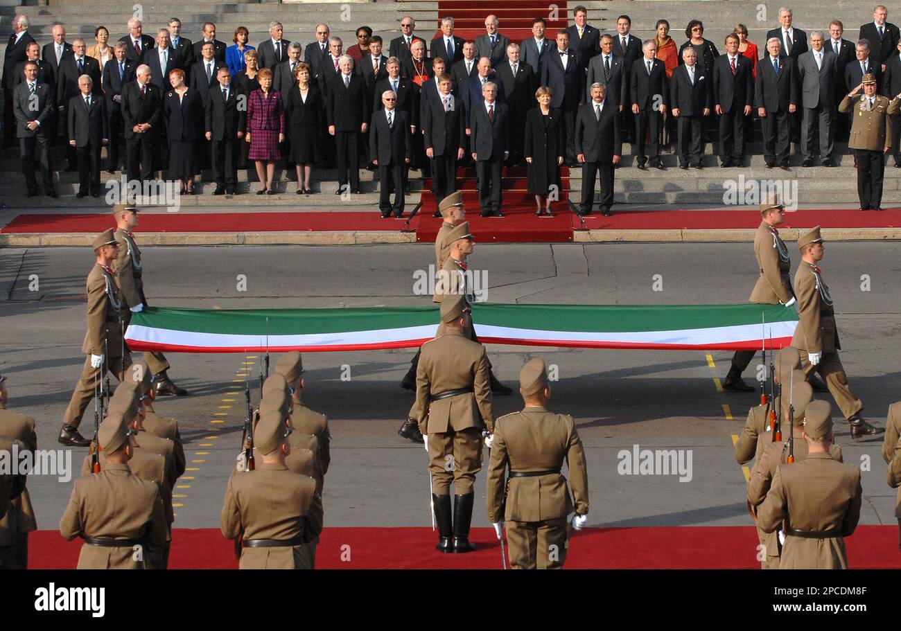 Hungarian guards of honor carry the national flag while guests, foreign ...