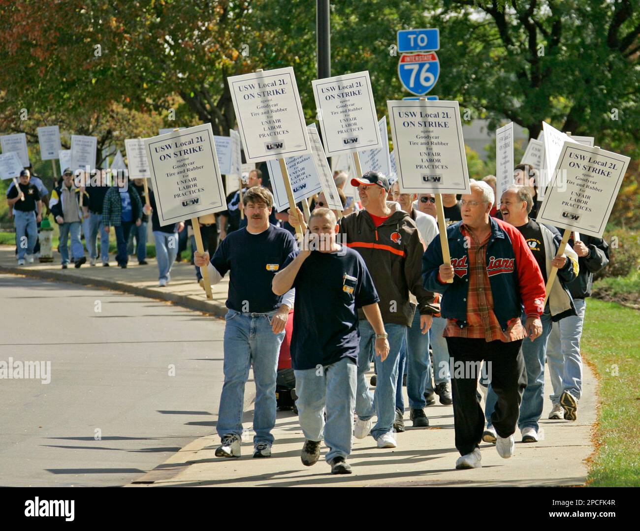 Goodyear workers march toward the company's headquarters in Akron, Ohio ...