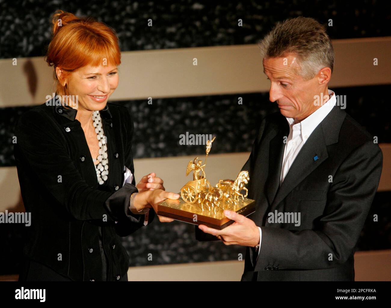 Journalist Lilli Gruber, left, hands over the 'Die Quadriga' award to ...