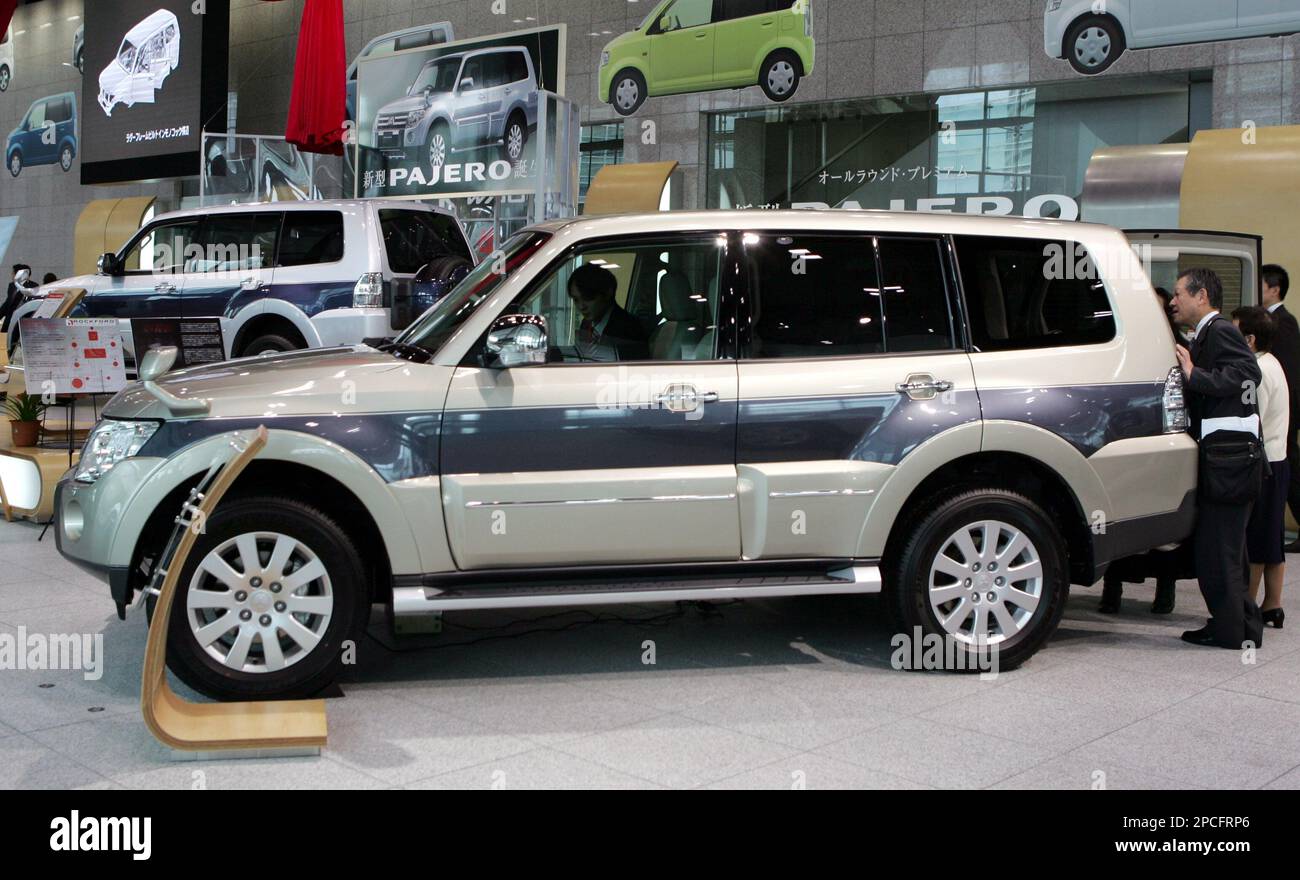 Visitors look at Mitsubishi Motors Corp.'s fully redesigned Pajero, the ...