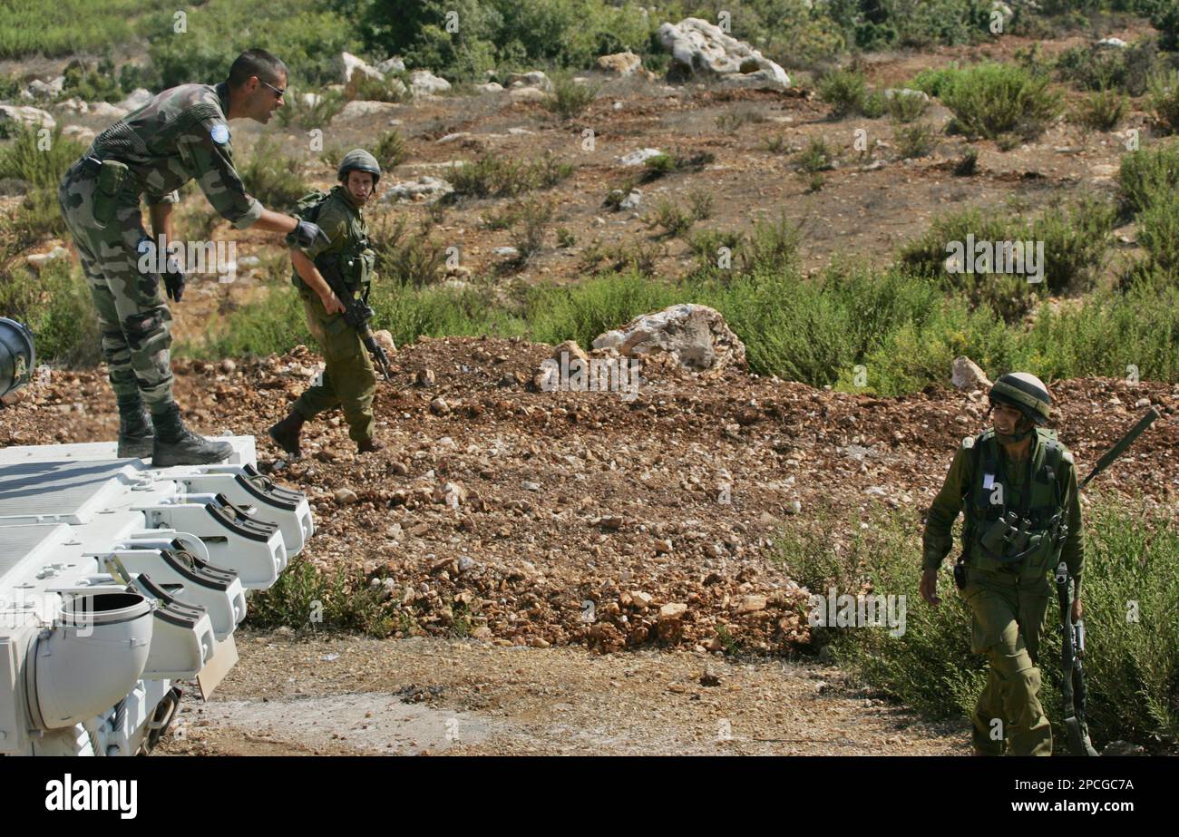 A French U.N. peacekeeper, left, atop his Leclerc tank gestures as he ...