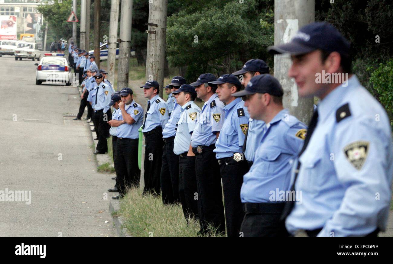 Georgian police officers stand along the perimeter of the Russian ...