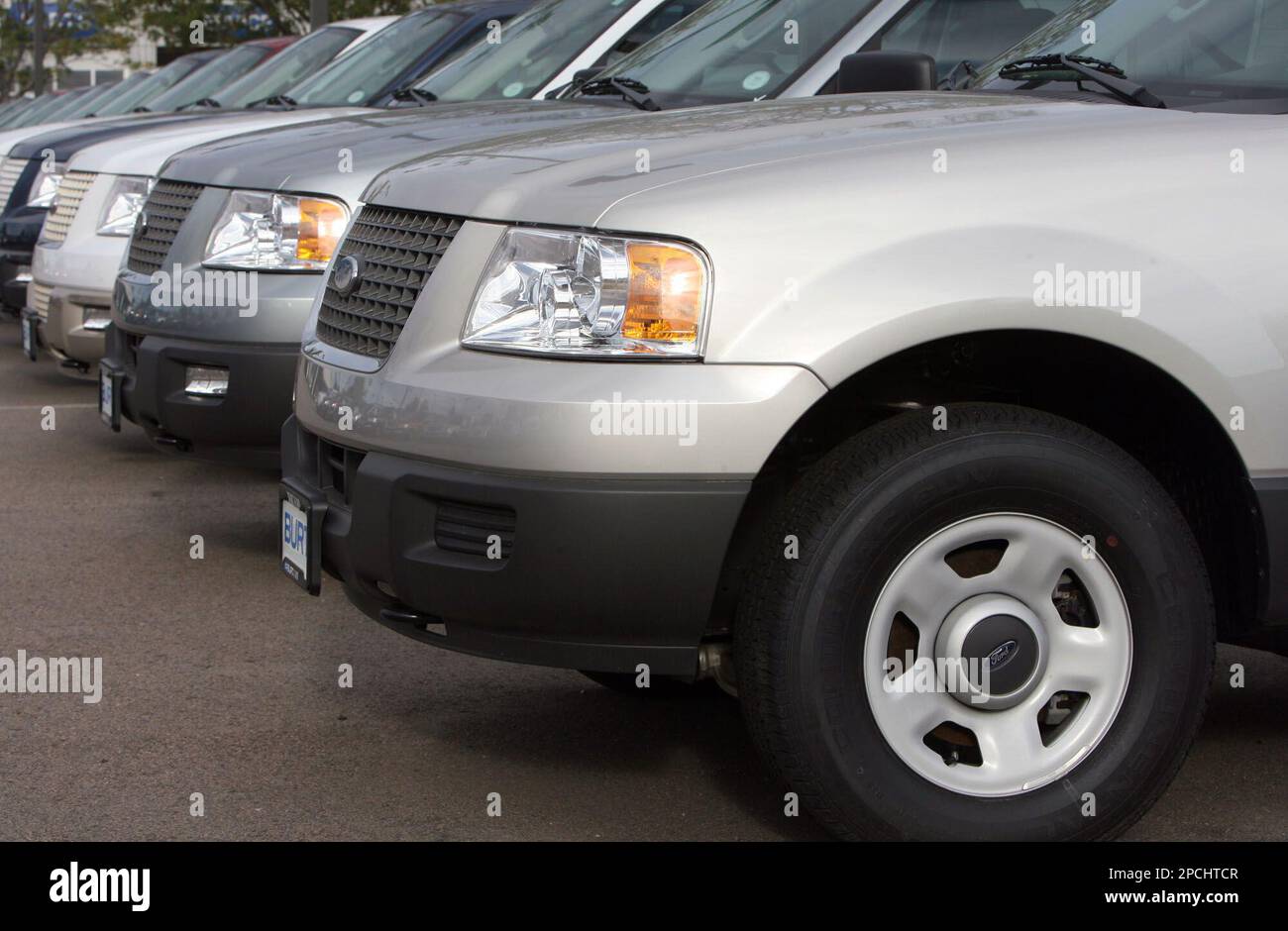 A long line of unsold 2006 Ford Expeditions sits on the lot of a Ford ...