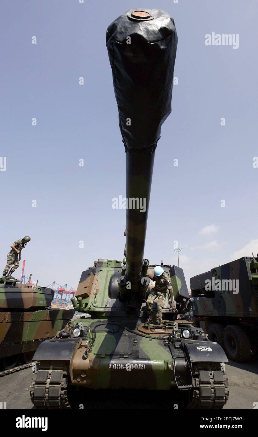 A French U.N. peacekeeper descends from atop a AUF1 artillery piece ...