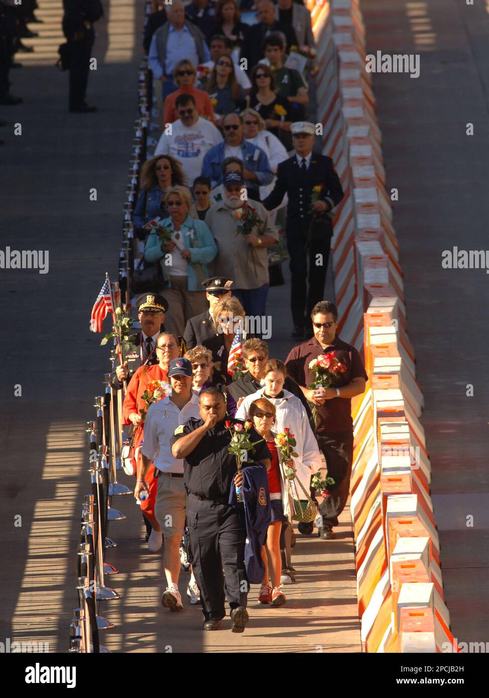 The first group of people are led down the ramp to the reflecting pools ...