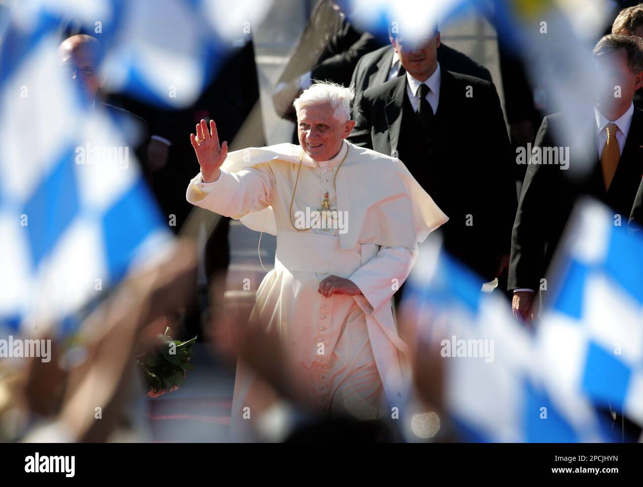 Pope Benedict XVI is seen waving through Bavarian flags after his ...