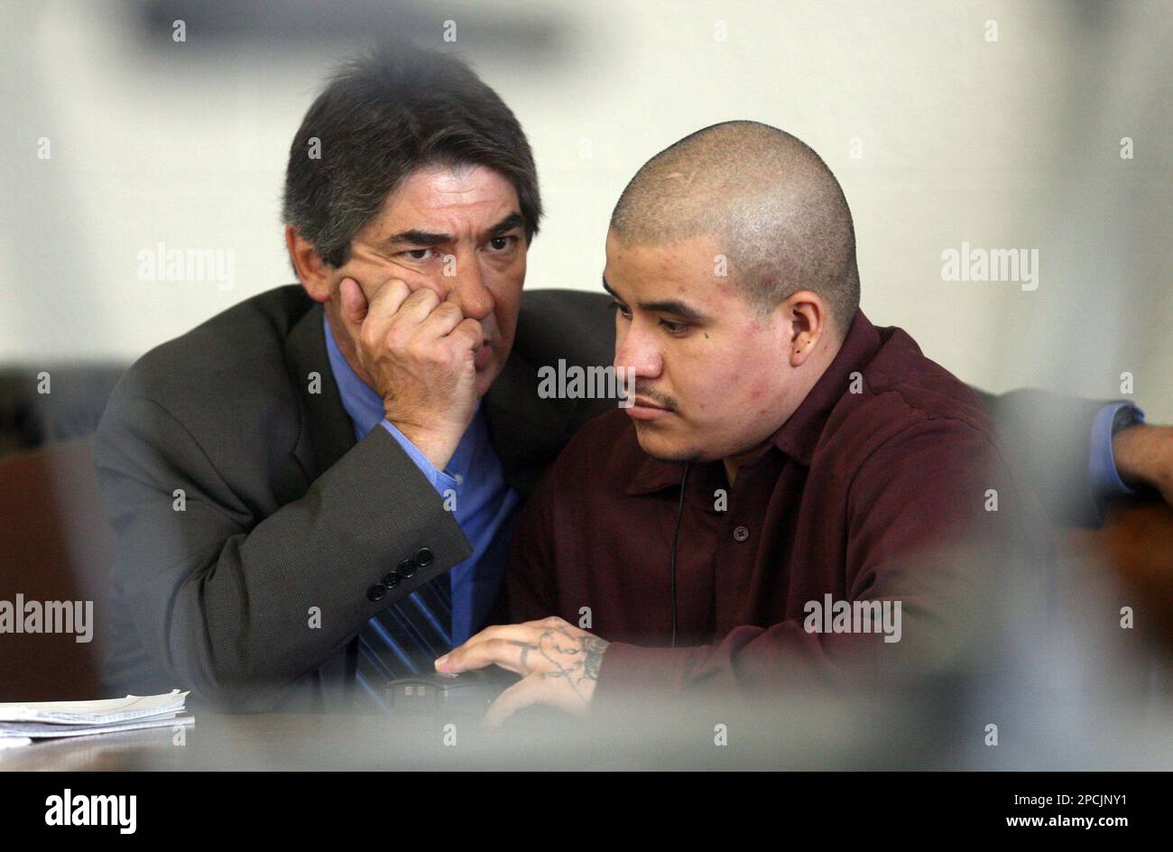 Defense attorney Fernando Freyre, left, talks with Raul Gomez-Garcia ...