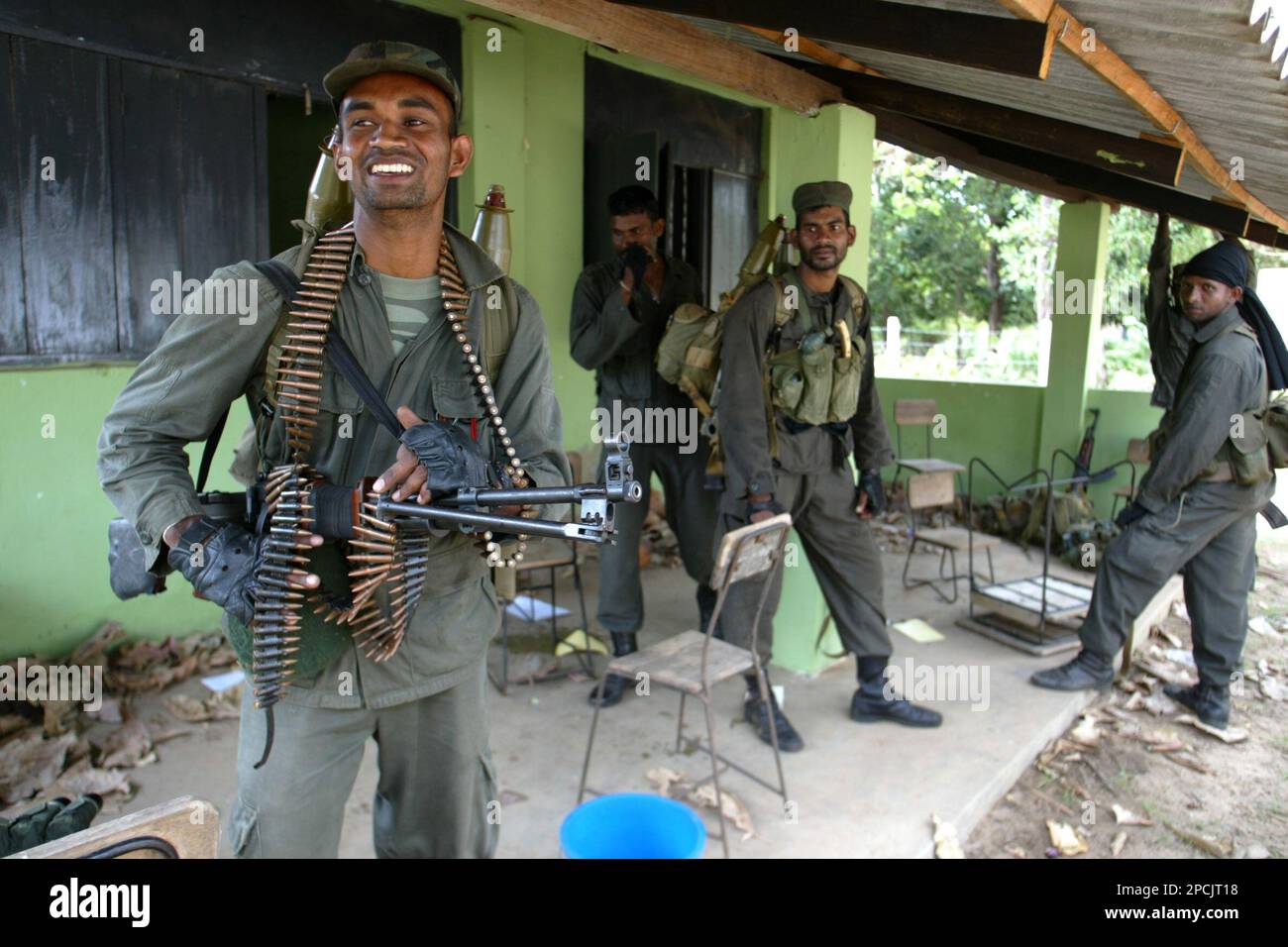 Sri Lankan Army soldiers rest in the shade of a building in Sampur ...