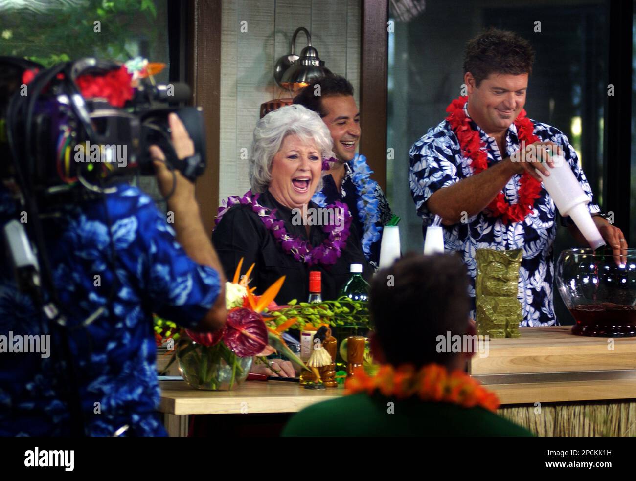 Paula Deen, center, and her sons Jamie, right, and Bobby, rear, tape ...
