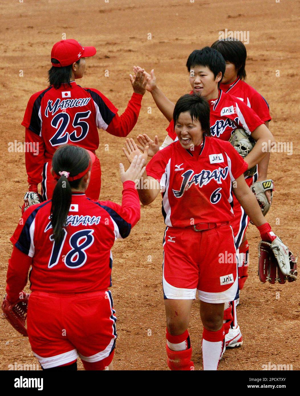 Japan's women soft ball team players celebrate their win against ...