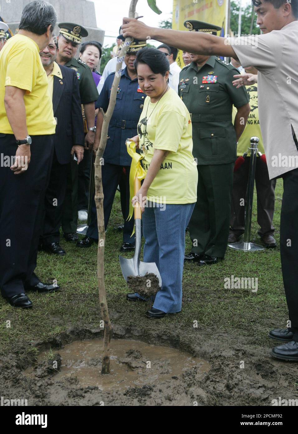 Philippine President Gloria Macapagal Arroyo, center, leads tree planting ceremonies during the ...