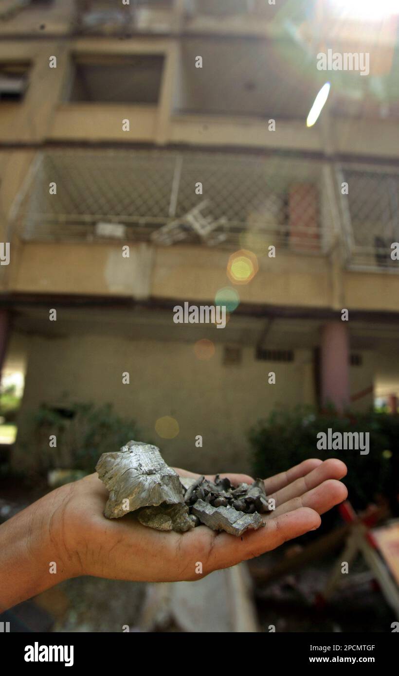 Ten-year-old Israeli Mike Kamiv, holds parts of a Hezbollah rocket ...