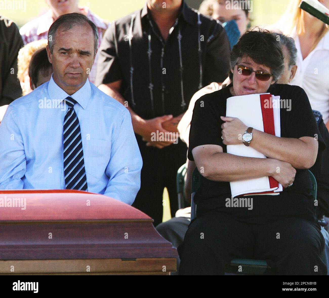 Gaetan Dalliare, left, looks on as his wife, Diane Dallaire, clutches ...