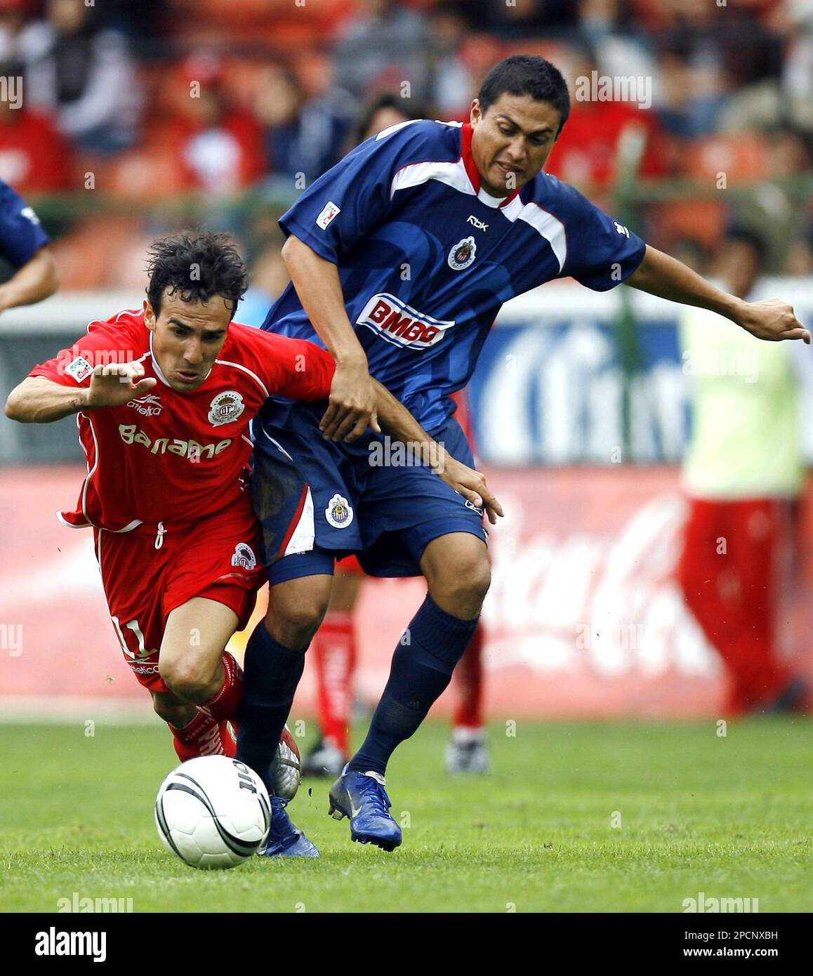 Toluca's soccer player Vicente Sanchez, left, from Uruguay, is fouled by Guadalajara's Jose ...