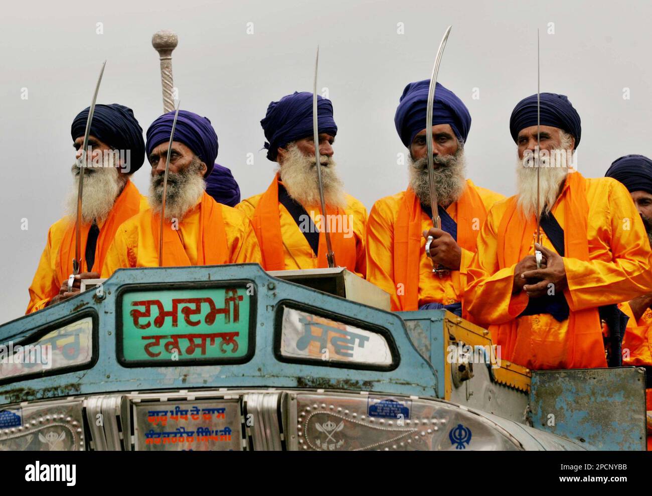 Five baptized Sikhs lead a religious procession during the 300th ...