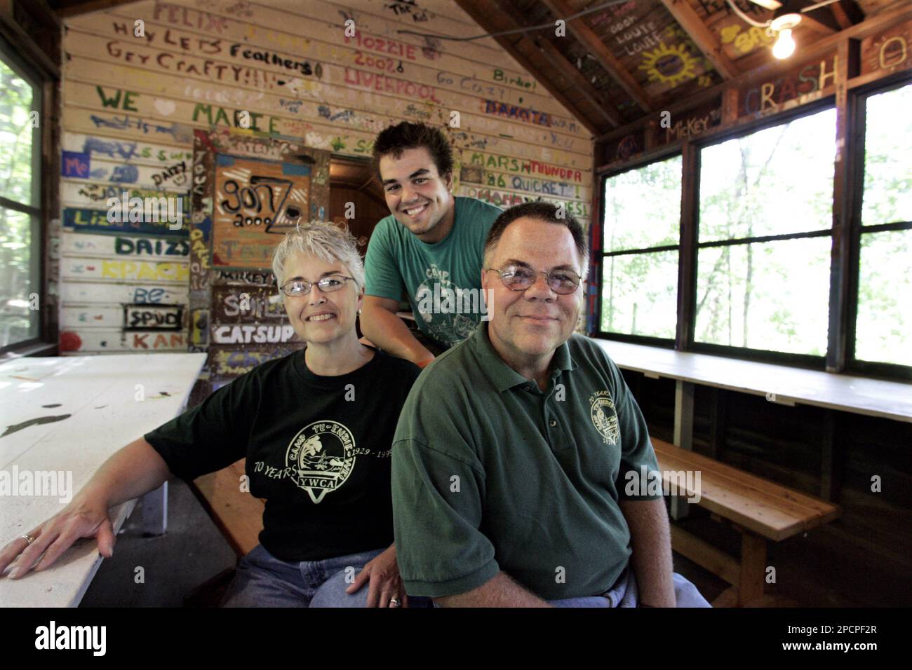 Lisa Eby, her husband Jim, right, and their son, Web, pose inside ...