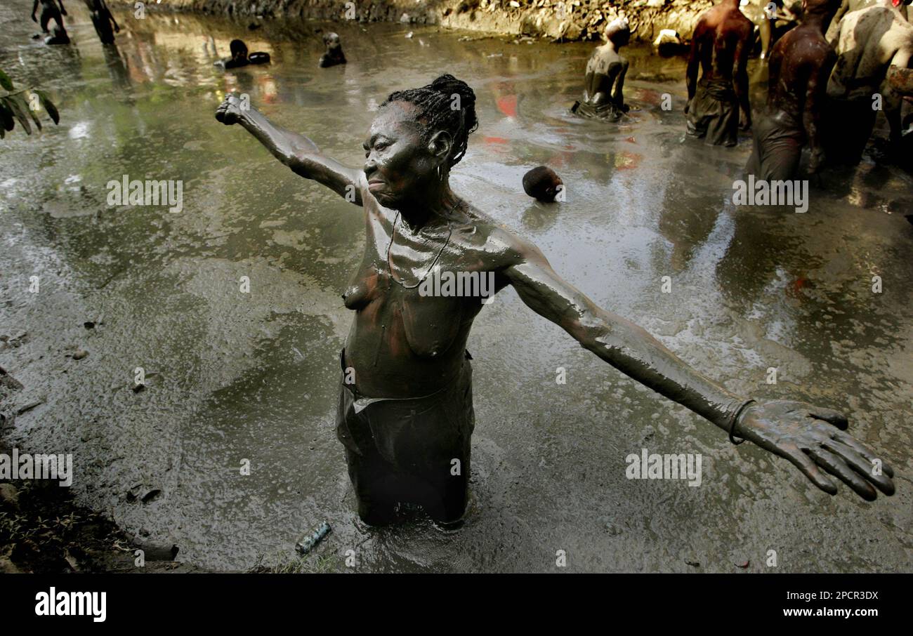 **EDS NOTE NUDITY** A voodoo believer stands in a mud pool during a voodoo ceremony at La Plaine ...