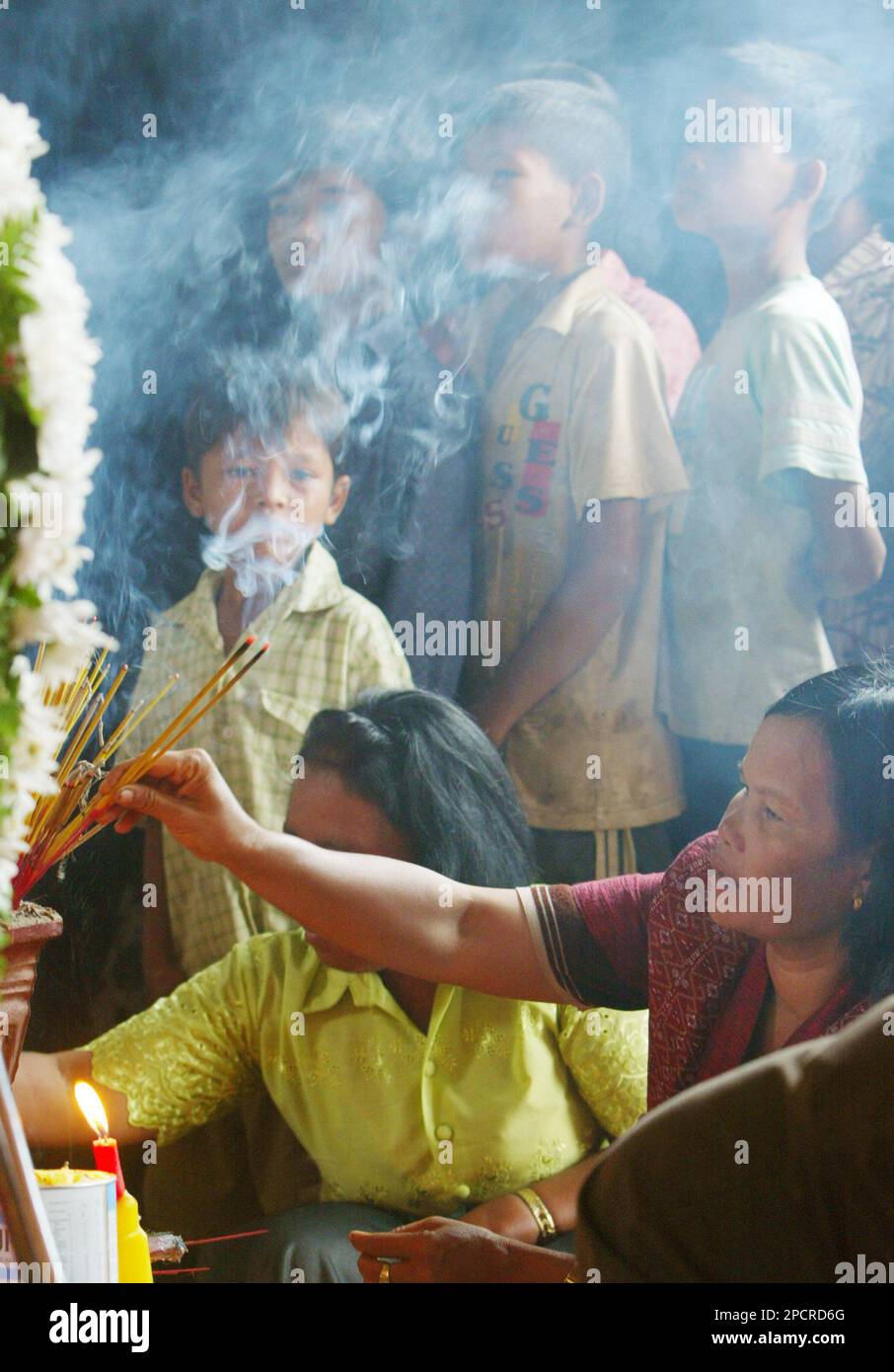 Relatives and friends of former Khmer Rouge chief Ta Mok light candles ...