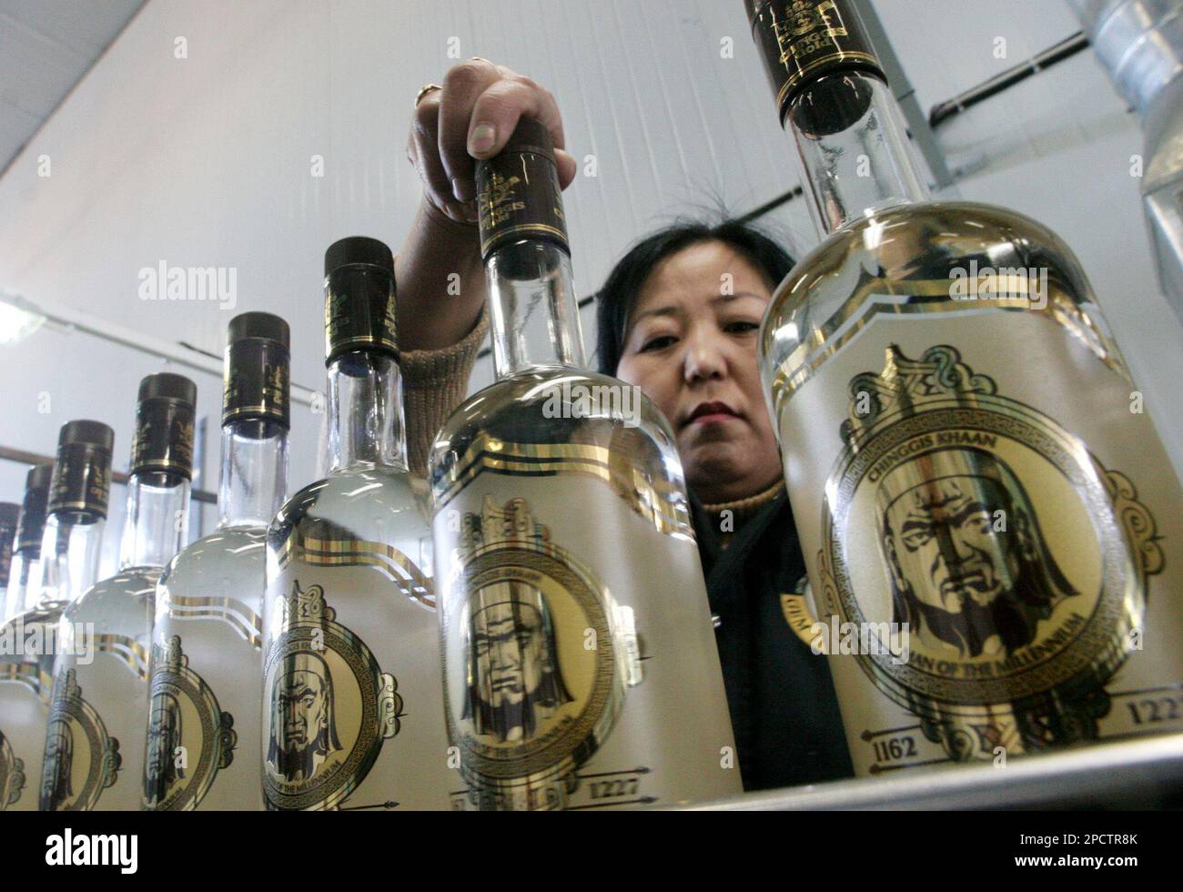 **FILE **A woman checks vodka bottles featuring an image of legendary ...