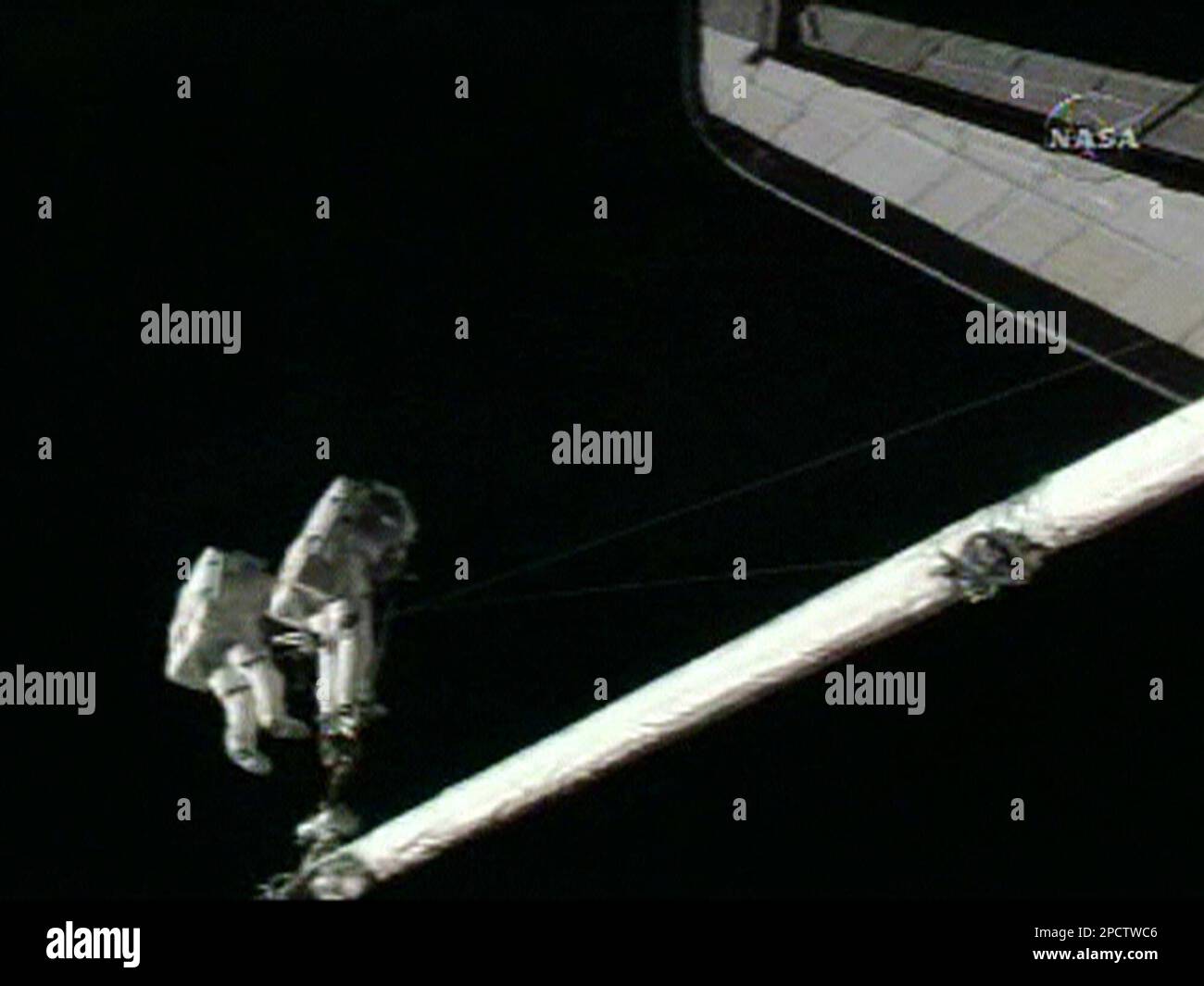 In this image made from NASA TV, astronaut Piers Sellers, left with ...