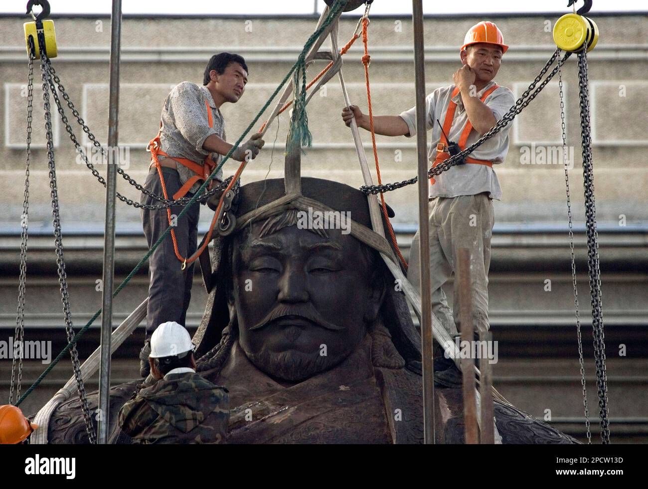 Workers installing a giant statue of Genghis Khan outside the Mongolian ...