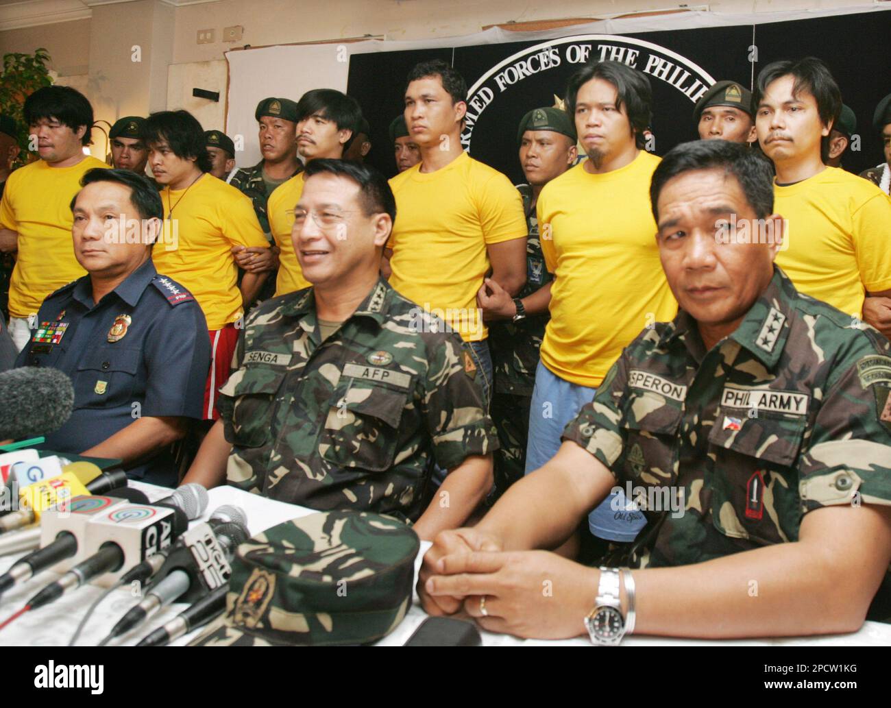Junior officers of the Philippine military (in yellow shirts) and a ...