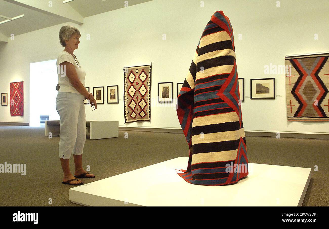Gail Heatherly looks over a collection of Navajo weaving and Edward ...