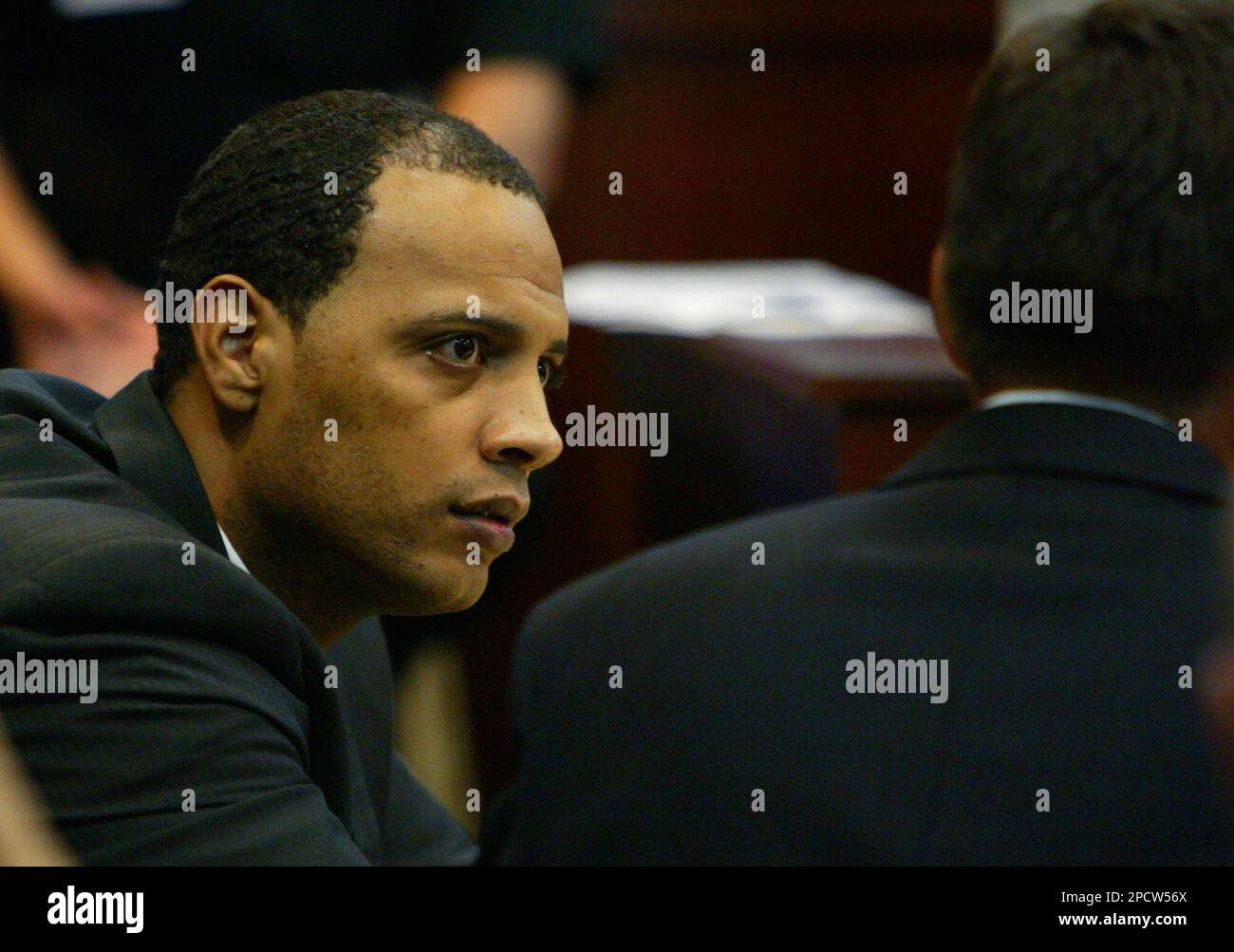 Troy Victorino talks to one of his defense lawyers during proceedings ...