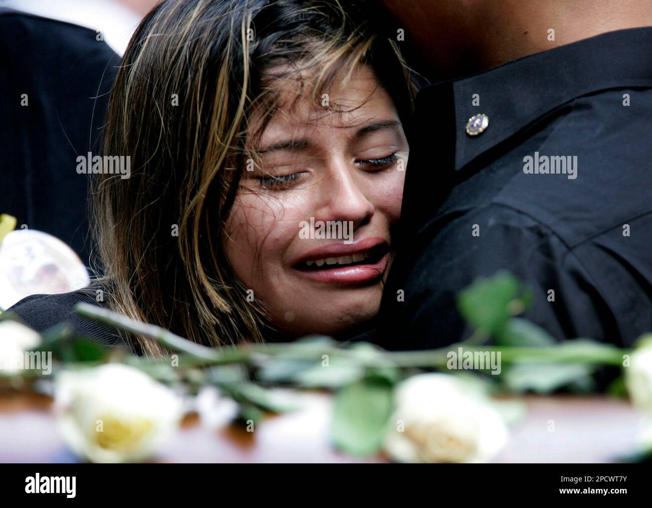 Christina Menchaca, 18, left, is comforted after family members placed ...