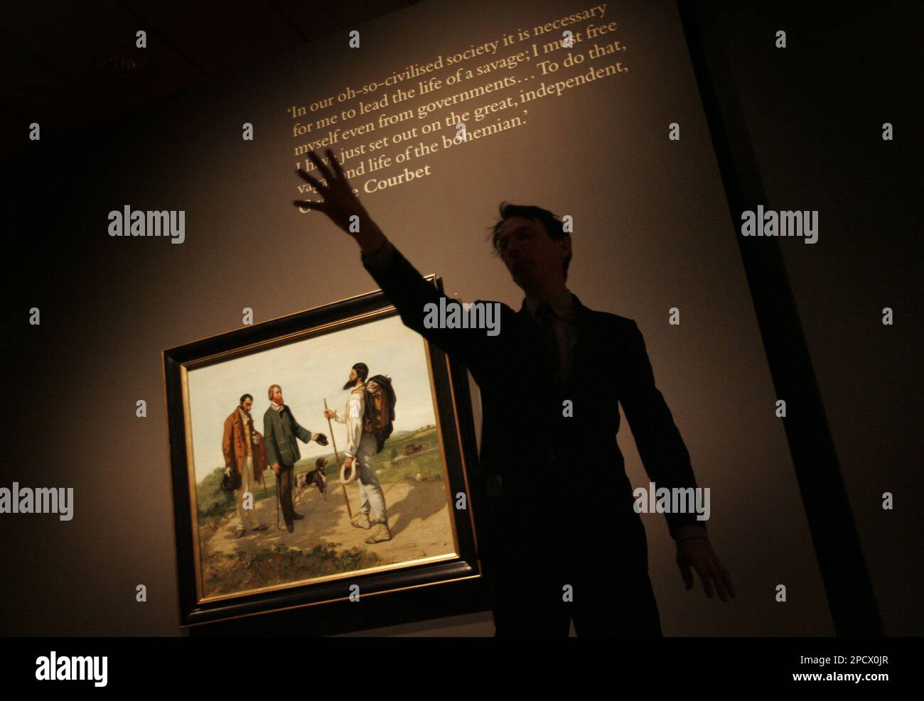 Backdropped by a 1854 painting of Jean Desire Gustave Courbet titled ...