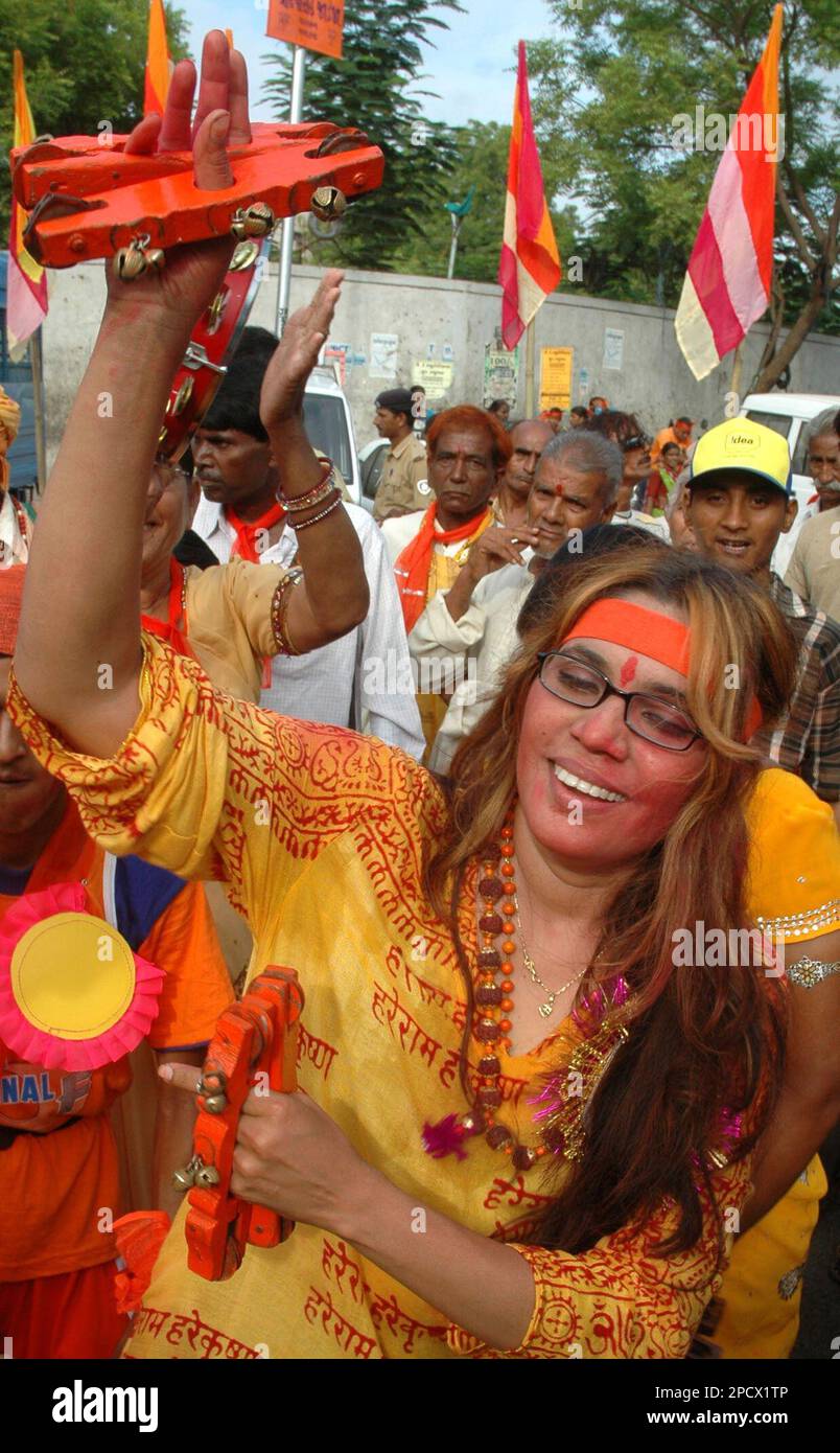 Devotees sing and dance as they pull a chariot during the 129th annual ...