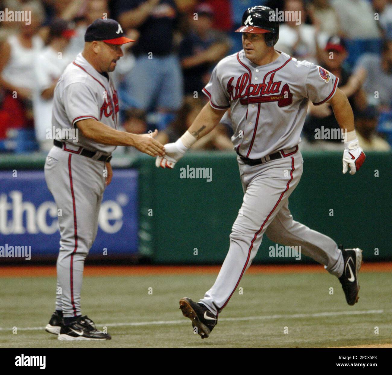 Atlanta Braves' Todd Pratt, right, is congratulated by third base coach ...