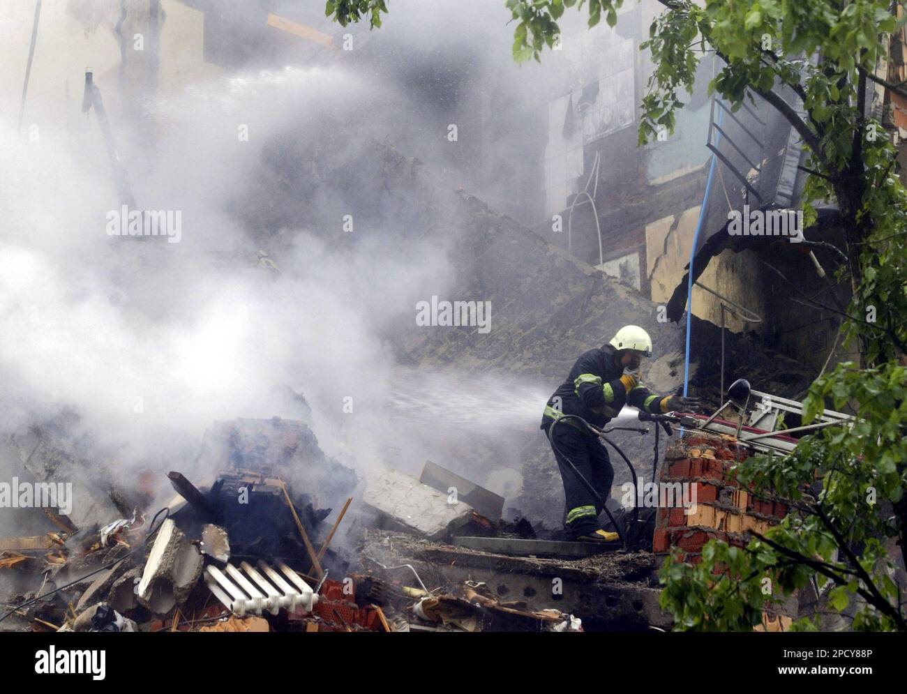 An Emergency Ministry officer uses a water pump to fight with a fire ...