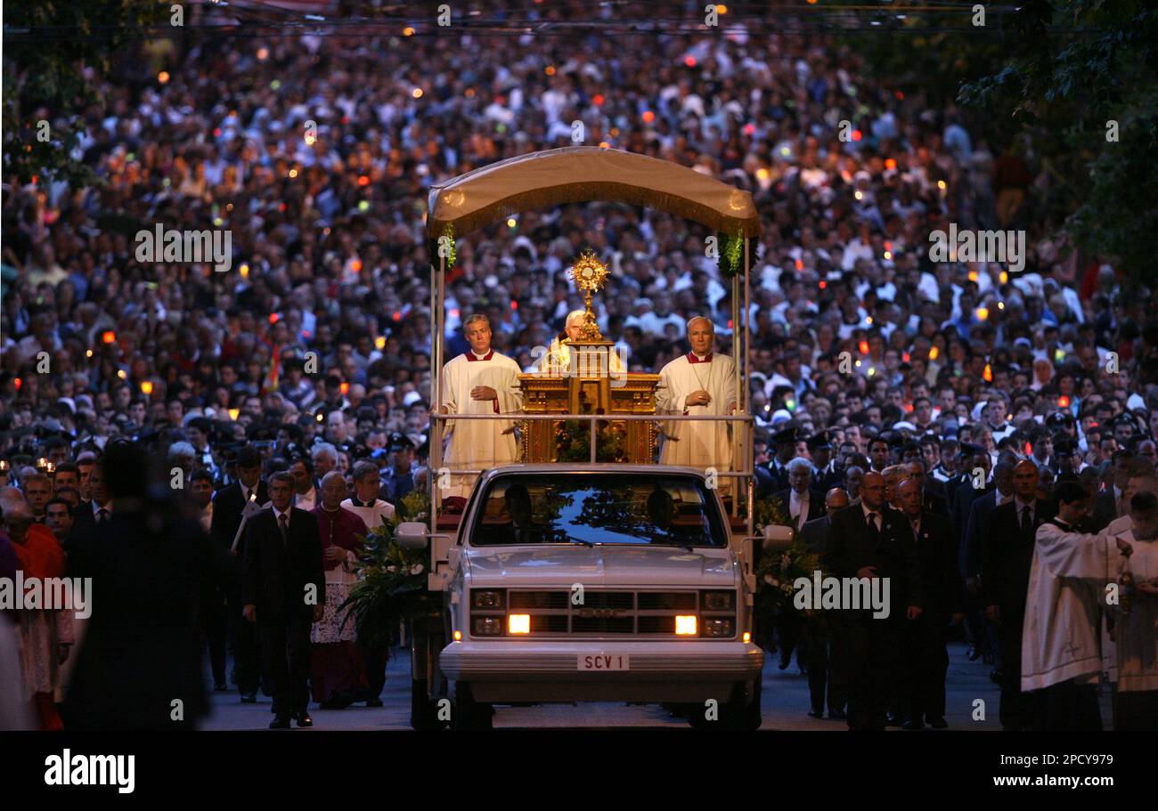 Pope Benedict XVI followed by the faithful, leads the Corpus Christi ...