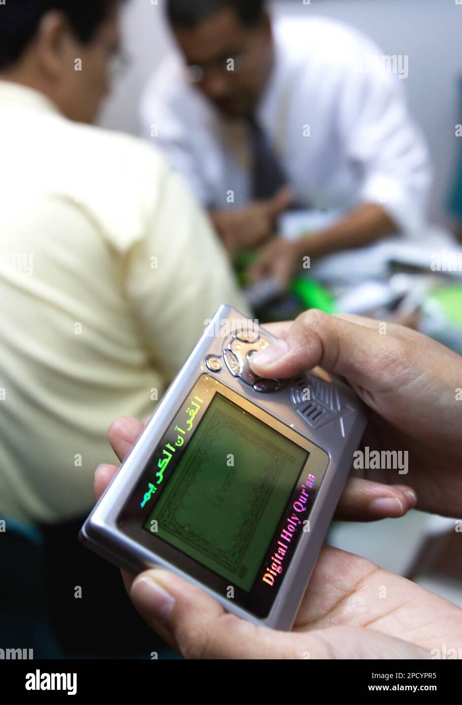Visitor tries out a Digital Holy Quran learning device at the Islamic ...