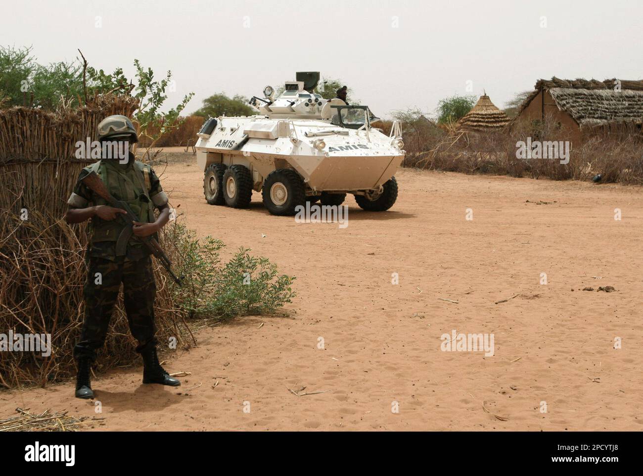 An African Union, AU soldier guards next to an APC during an AU patrol ...
