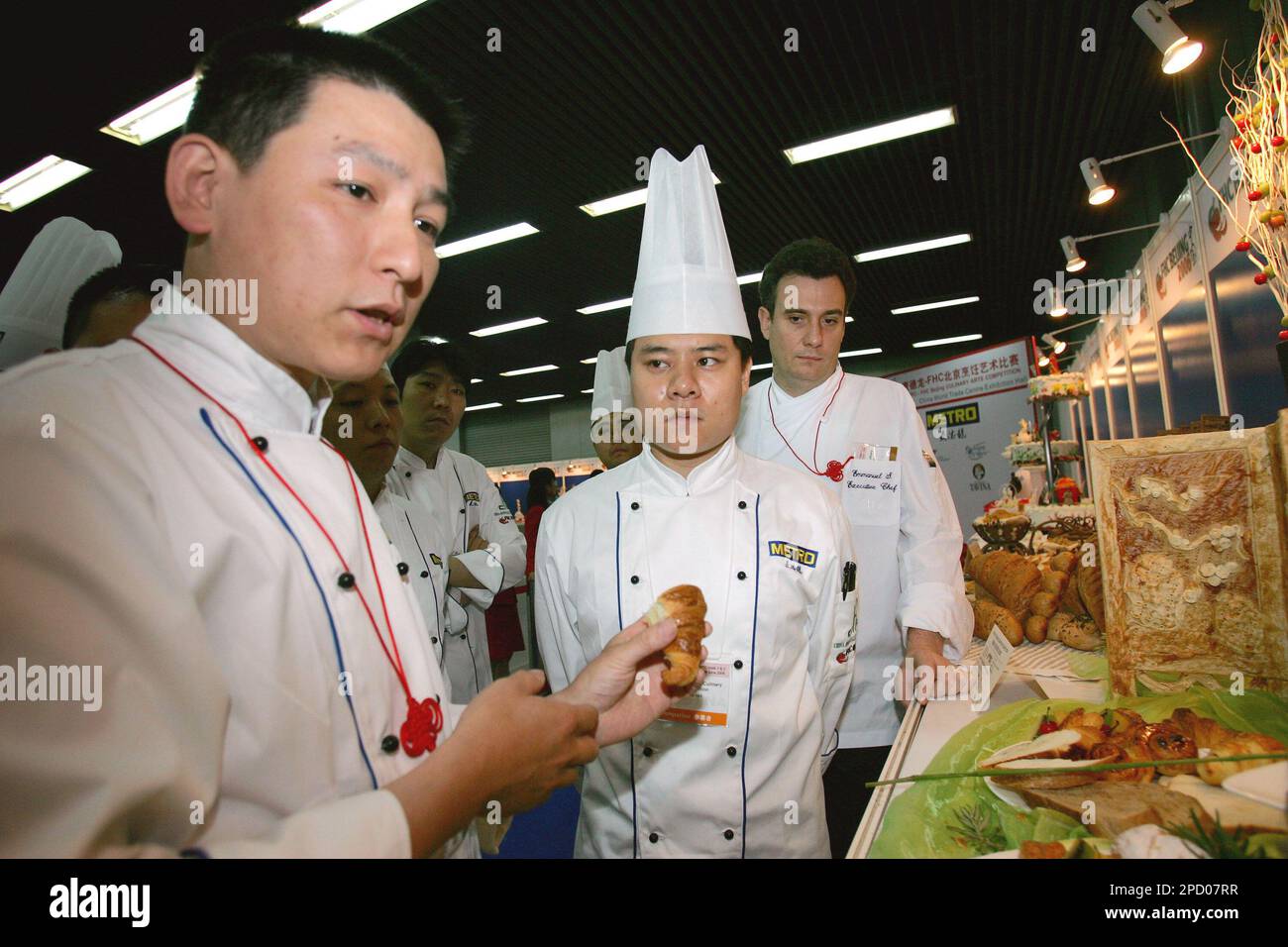 Chinese chefs study the consistency of a properly made croissant under ...