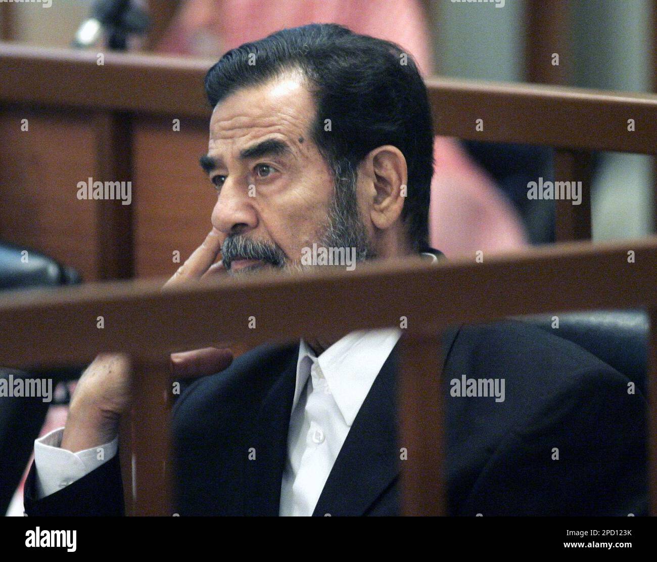 Former Iraqi president Saddam Hussein listens to defence witness ...