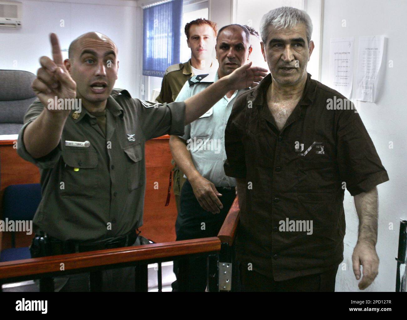 An Israeli border police officer gestures as the leader of the Popular ...