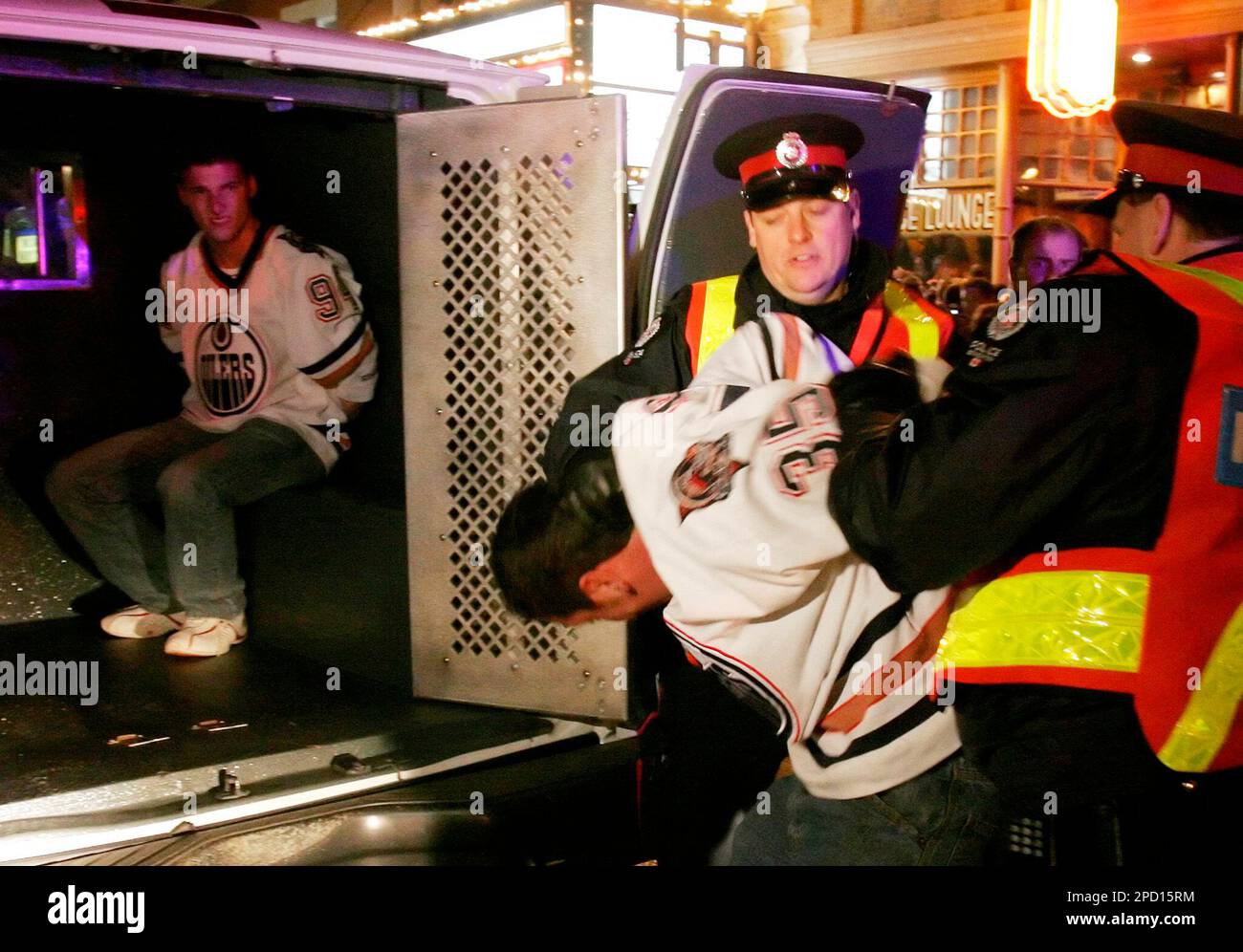Police arrest two Edmonton Oilers fans on Saturday May 27, 2006, after ...