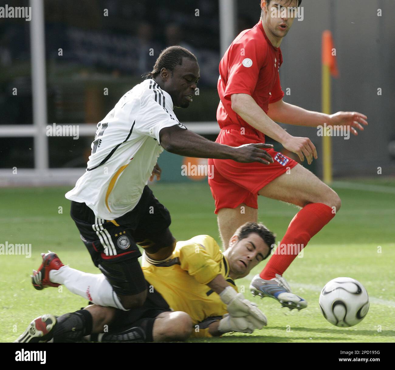 Germany's Gerald Asamoah, left, falls over Luxembourg's goalie Marc ...