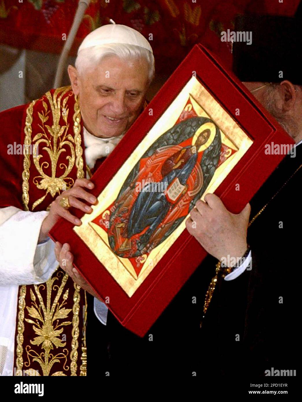 Pope Benedict XVI holds an orthodox icon he just received from an ...