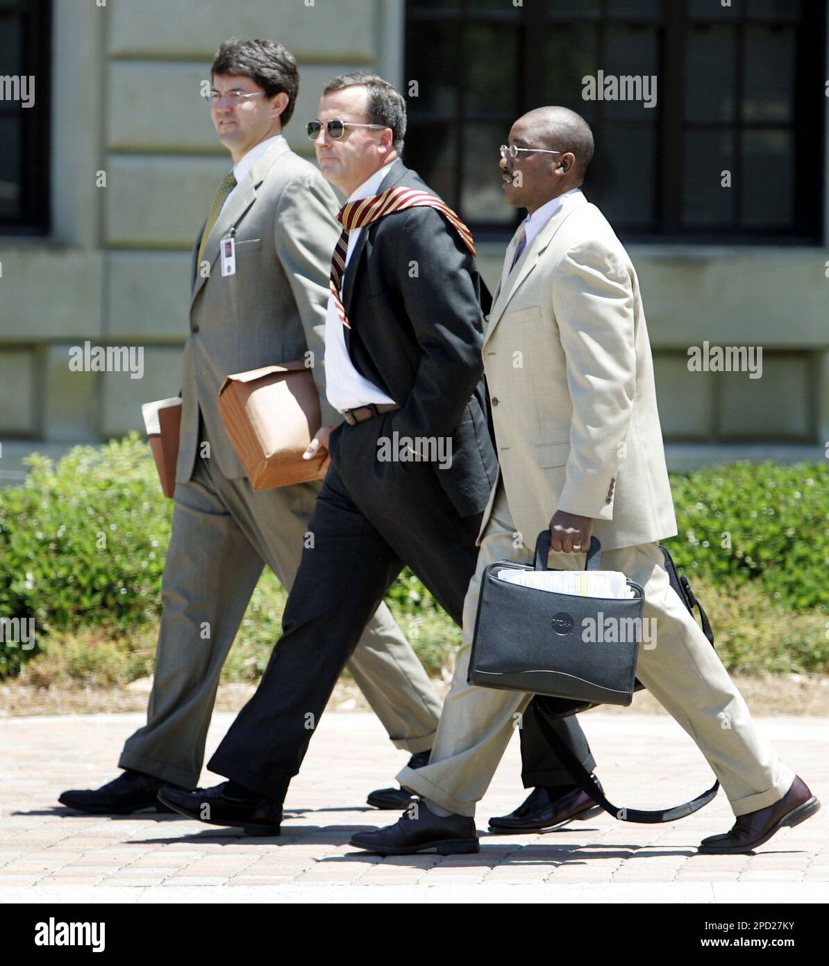 Prosecutors J.B. Perrine, left, Steve Feaga, middle, and Louis V ...
