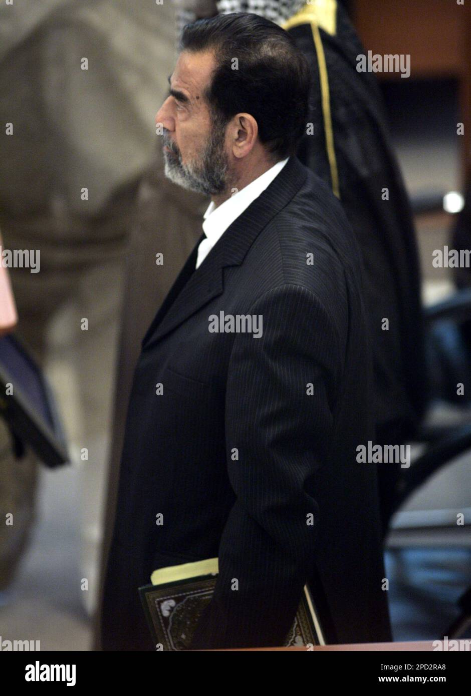 Former Iraqi leader Saddam Hussein attends his trial at a court in the ...