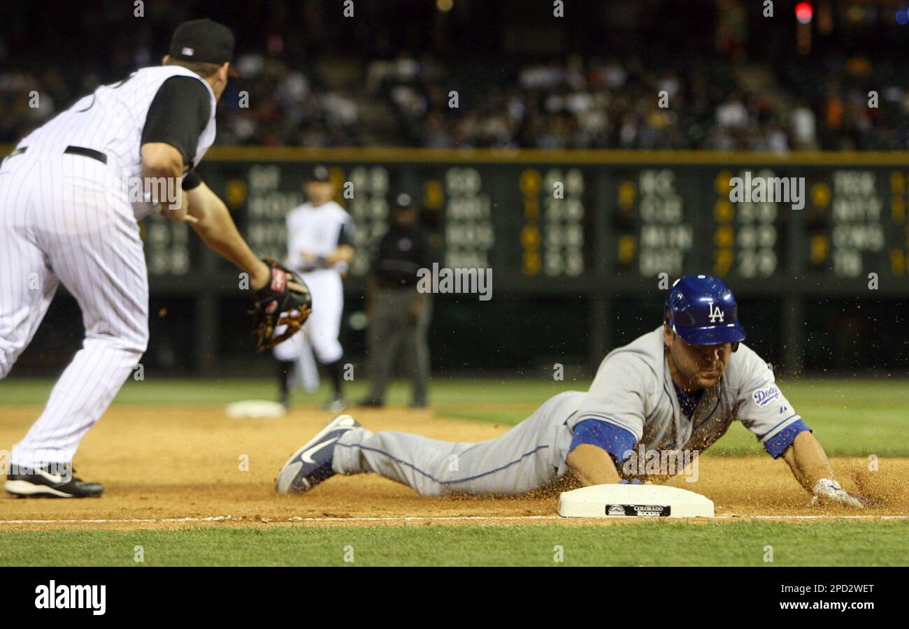 Los Angeles Dodgers' Russell Martin slides safely into third base with ...