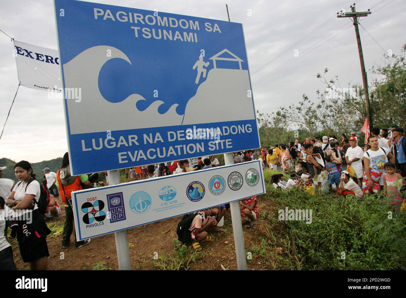 Filipino villagers rest as they reach a hilltop evacuation site during the first-ever ...